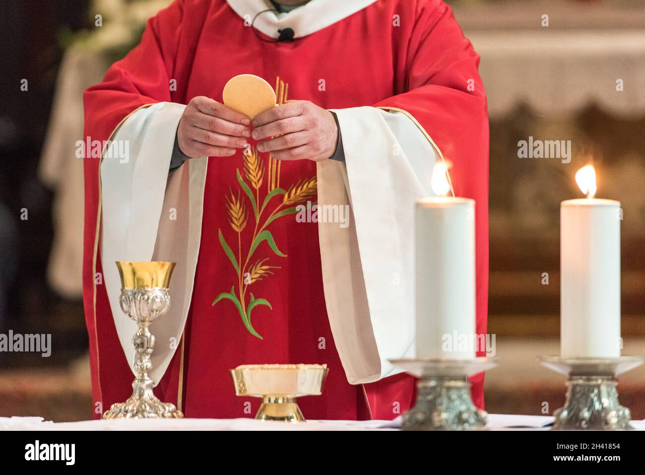 Priest giving Eucharist Stock Photo - Alamy
