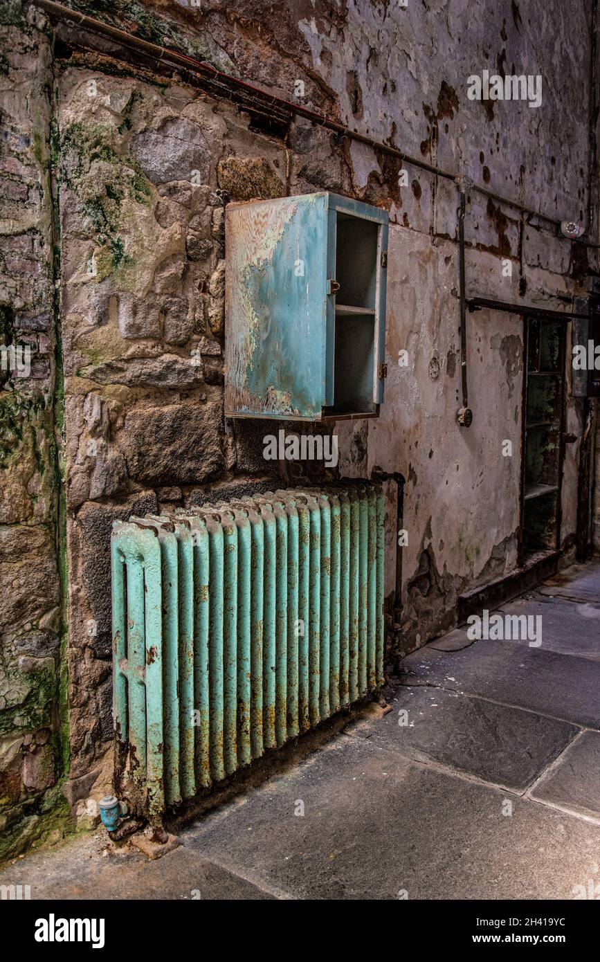 Old rusty radiator and little locker in an old building, Eastern State ...