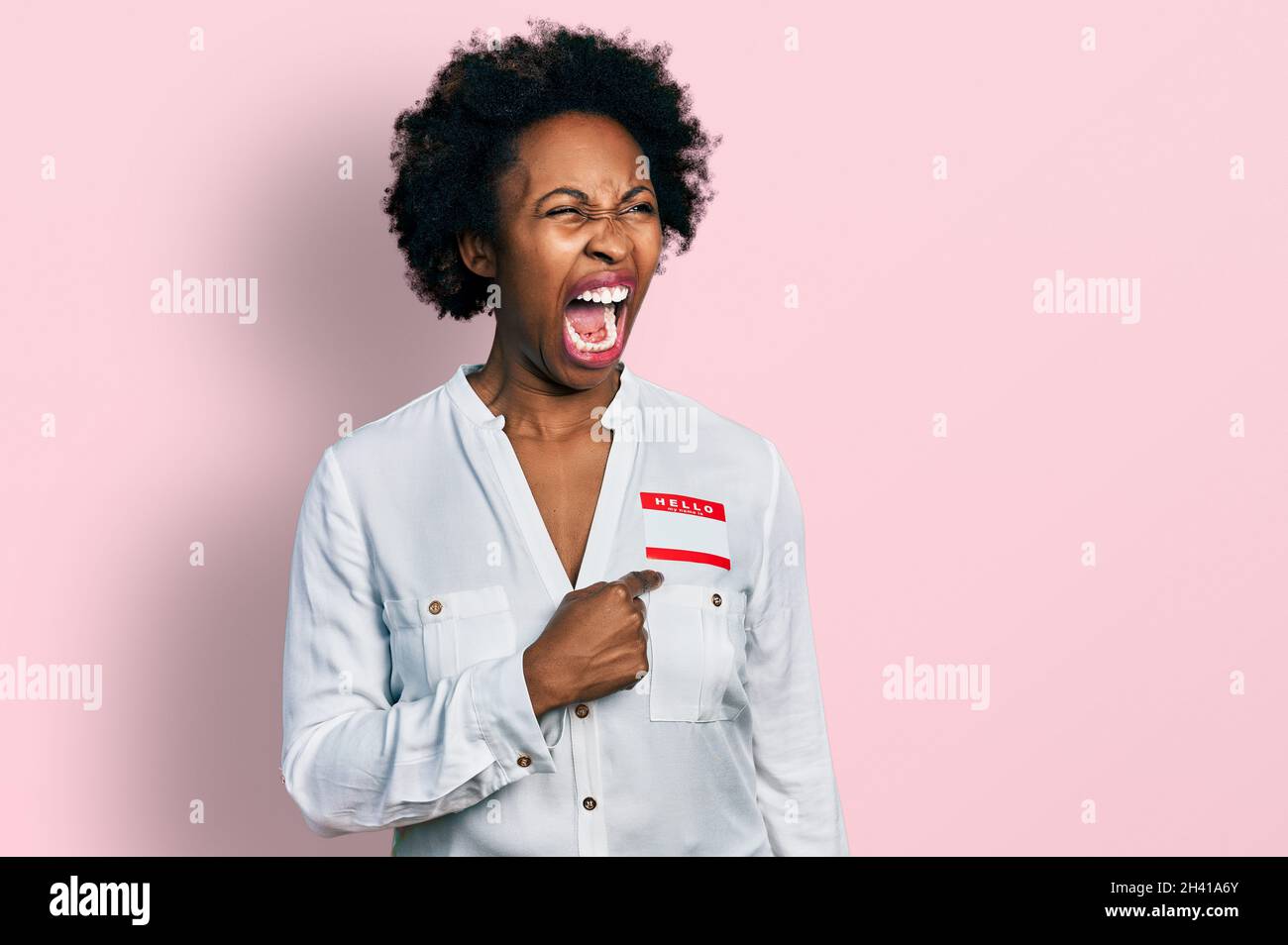 African american woman with afro hair wearing hello my name is sticker ...