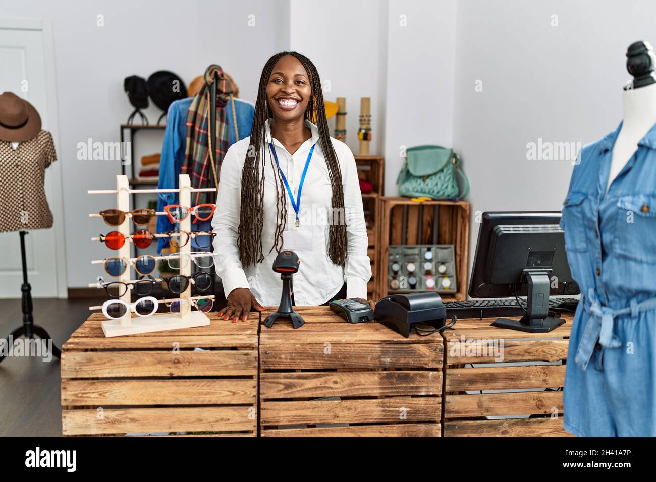 Young african american shopkeeper woman smiling happy standing by the ...