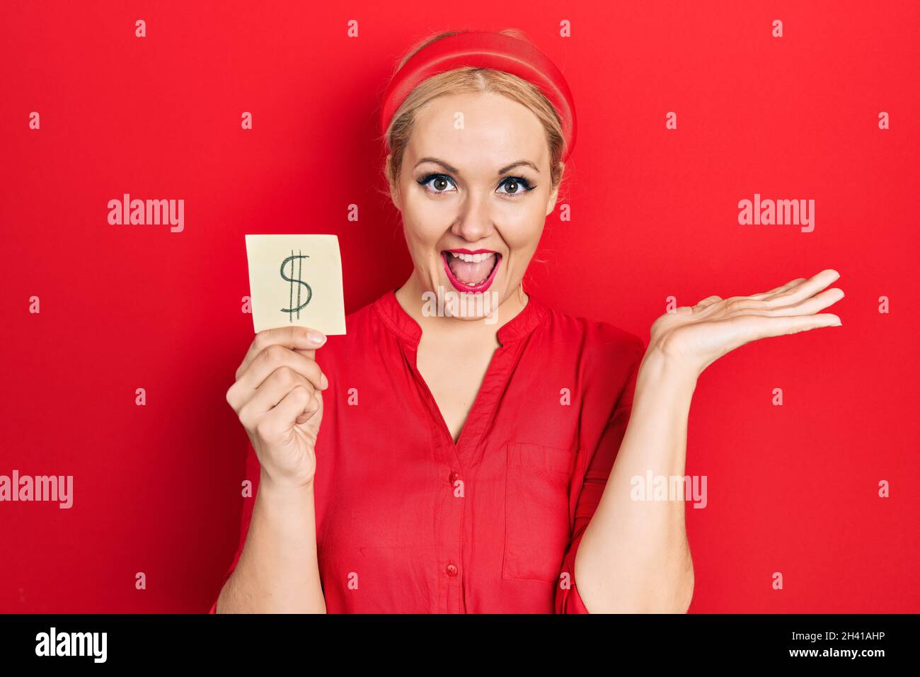 Young blonde woman holding dollar symbol reminder paper celebrating ...