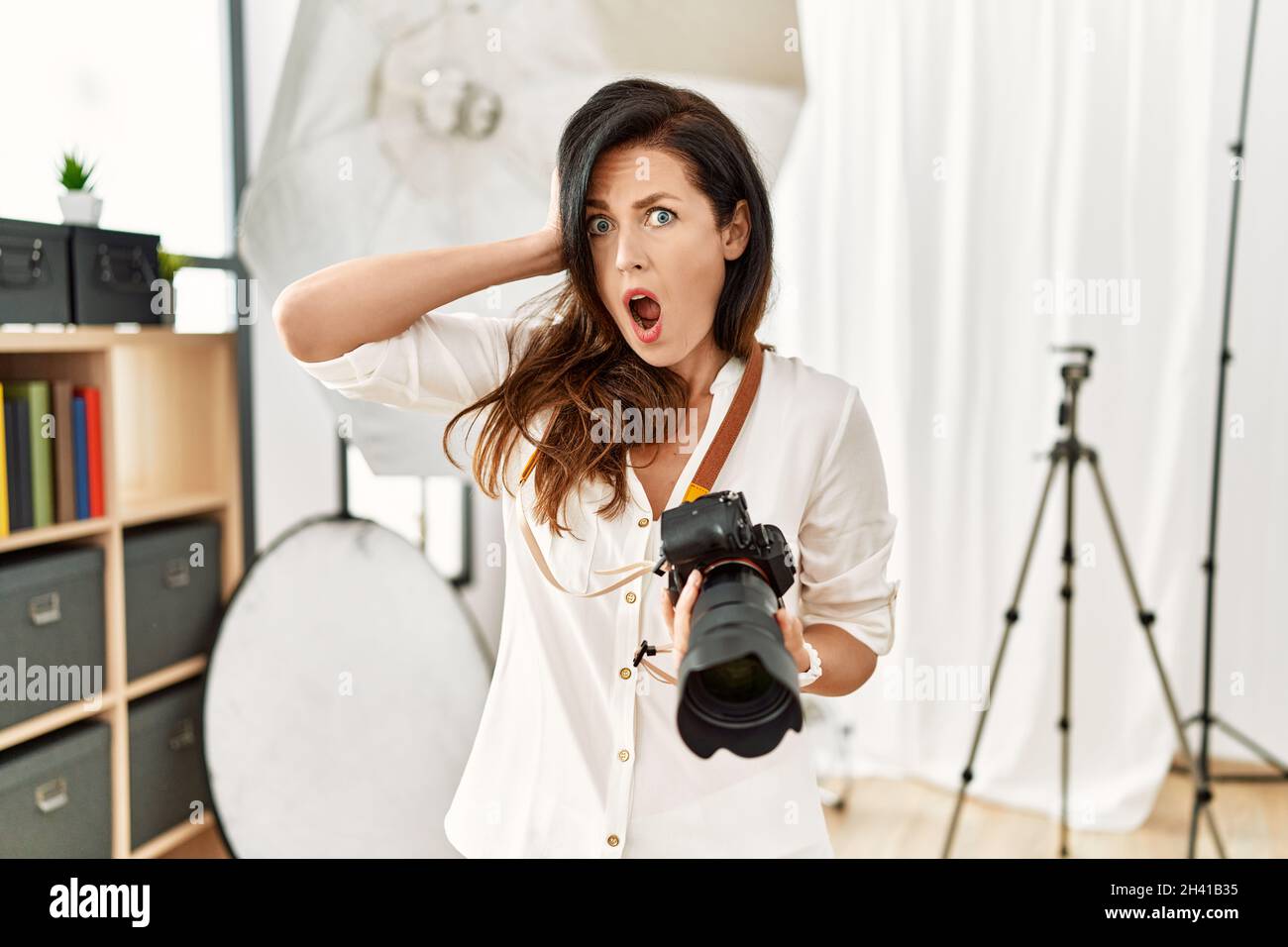 Beautiful caucasian woman working as photographer at photography studio ...