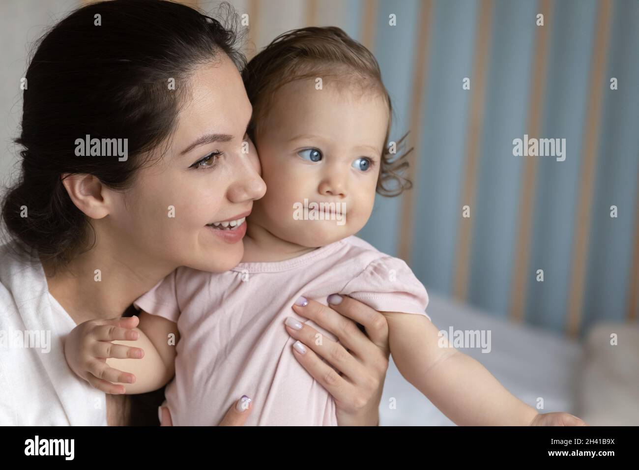 Head shot smiling dreamy mother hugging little daughter, dreaming Stock Photo - Alamy