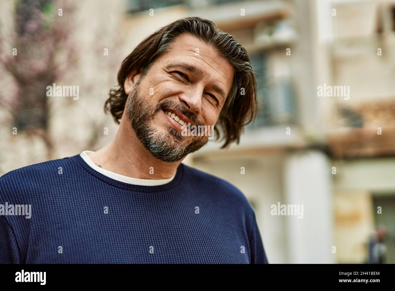 Middle age handsome man smiling at the town Stock Photo - Alamy