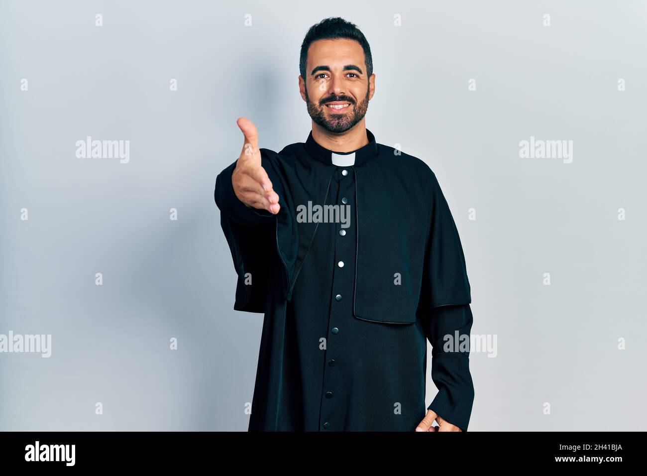 Priest catholic church shake hands hi-res stock photography and images ...