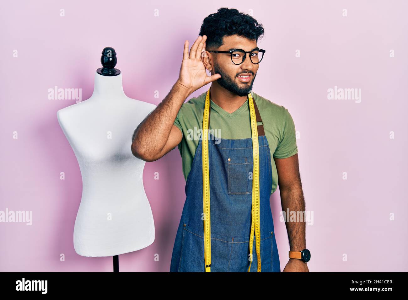 Arab man with beard dressmaker designer wearing atelier apron smiling ...