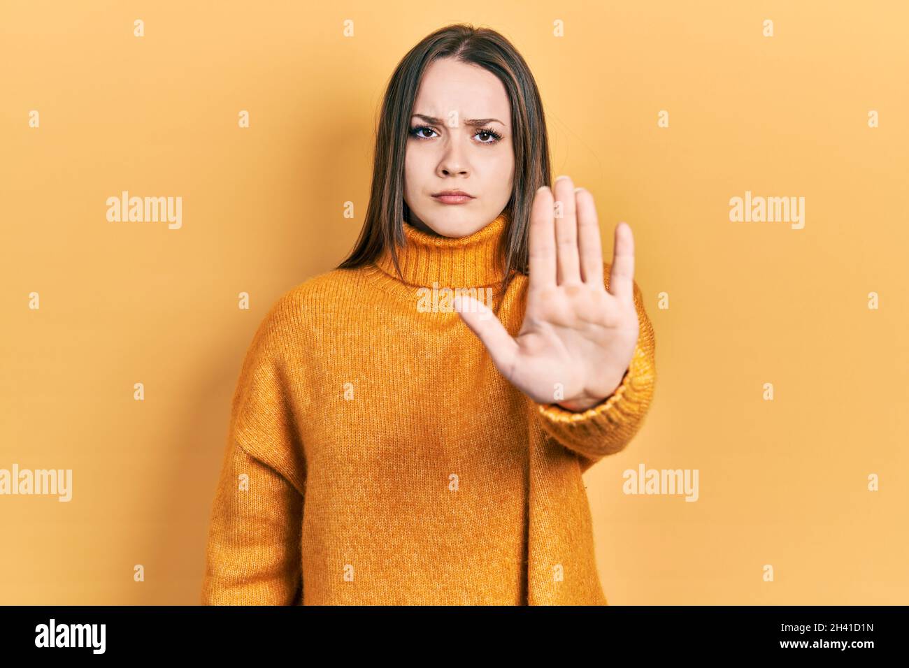 Young Hispanic Girl Wearing Casual Clothes Doing Stop Sing With Palm Of
