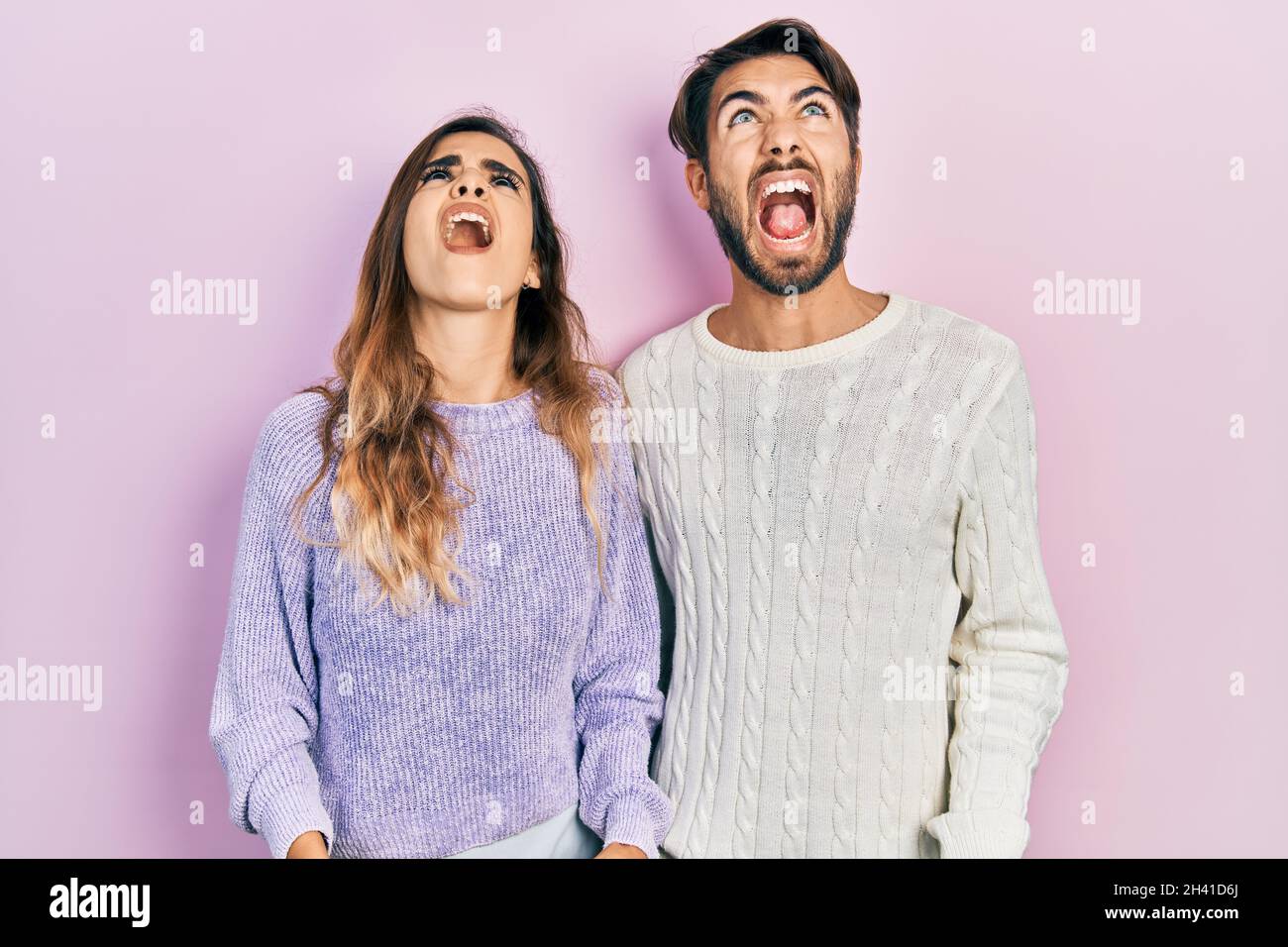 Young hispanic couple wearing casual clothes angry and mad screaming ...