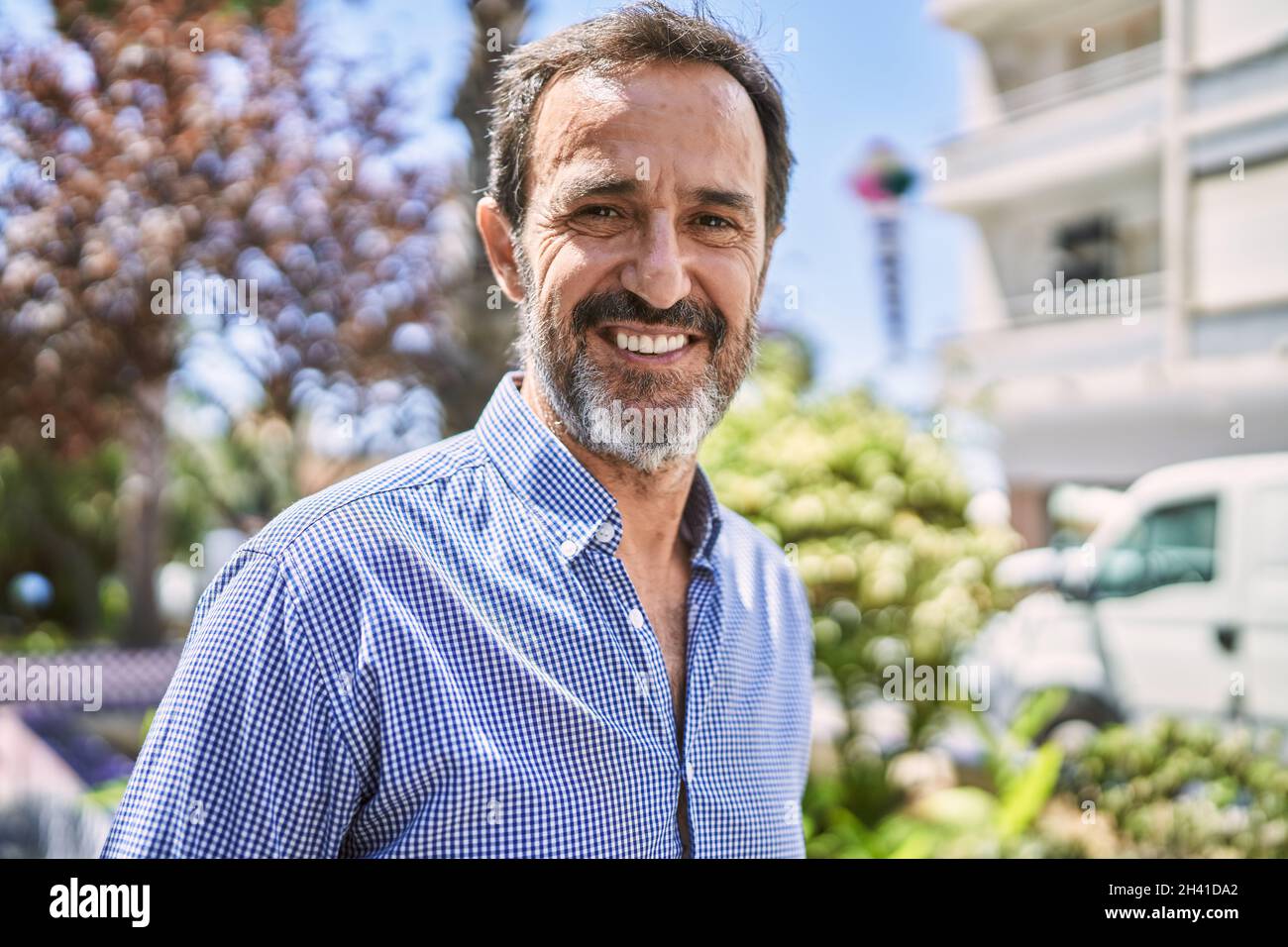 Middle age hispanic man smiling happy standing at the city Stock Photo ...