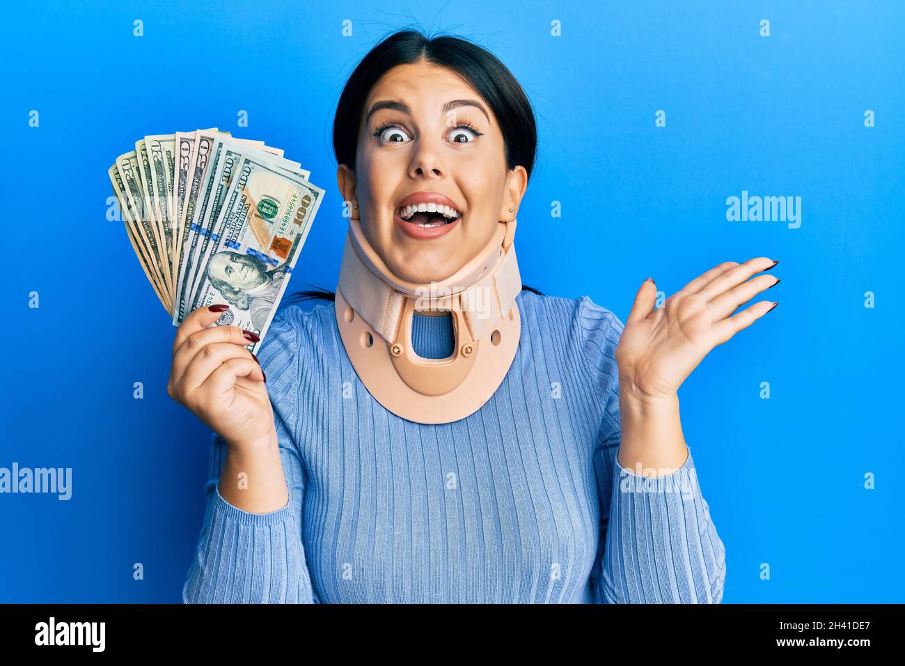 Beautiful brunette woman wearing cervical collar holding insurance ...
