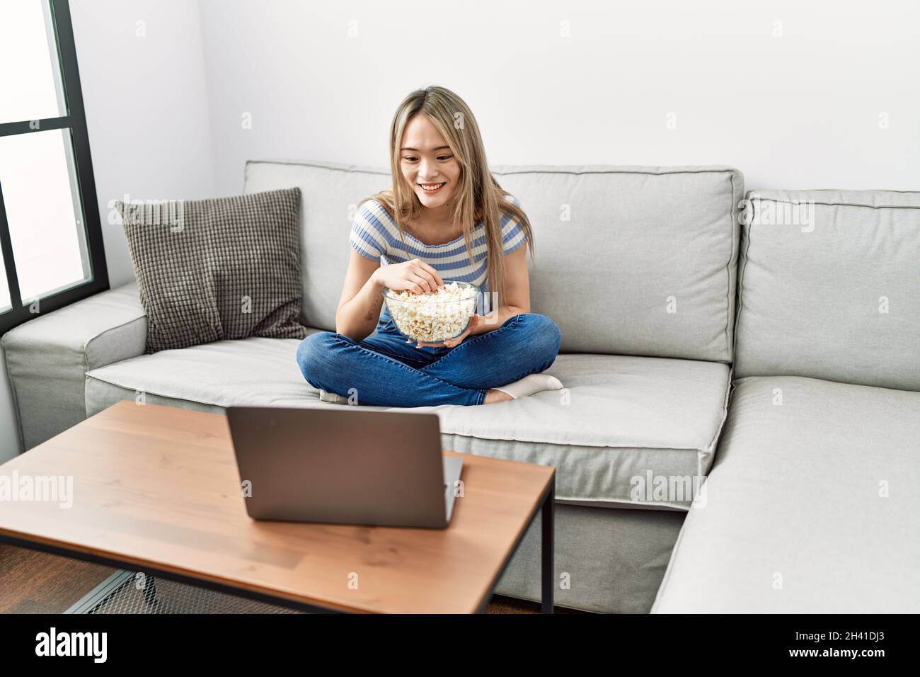 Young chinese woman smiling confident watching movie at home Stock ...