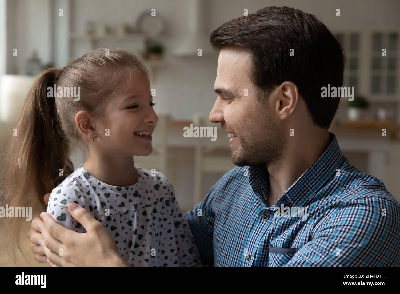 Happy small kid girl talking with joyful father Stock Photo - Alamy