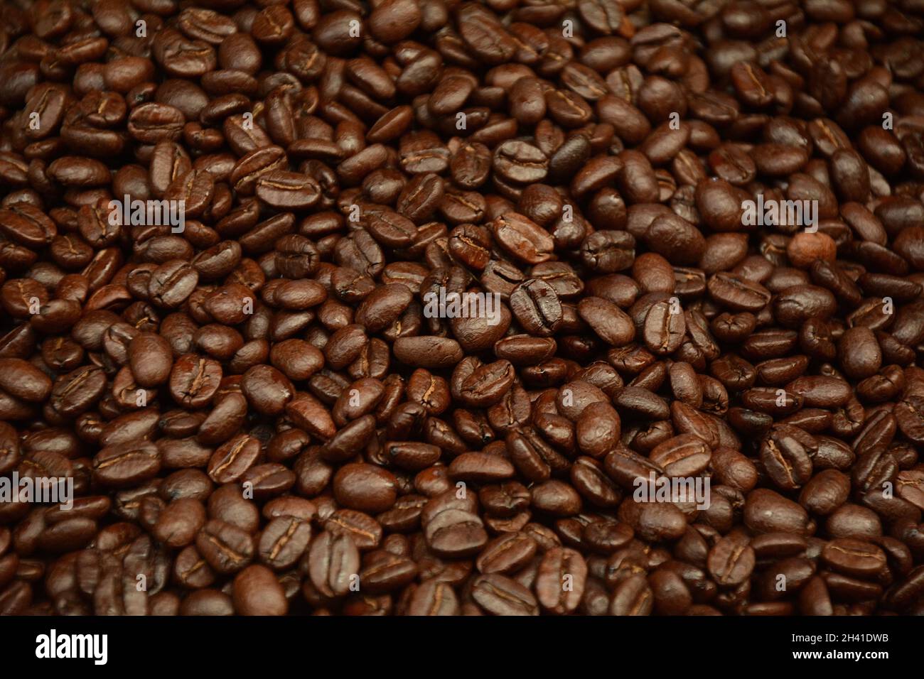 Roasted coffee beans background. Coffee beans in front of spice shop in ...