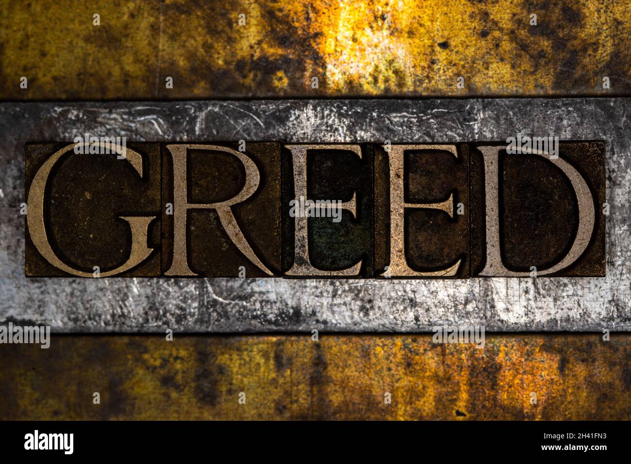 Greed text message on textured grunge copper and vintage gold ...