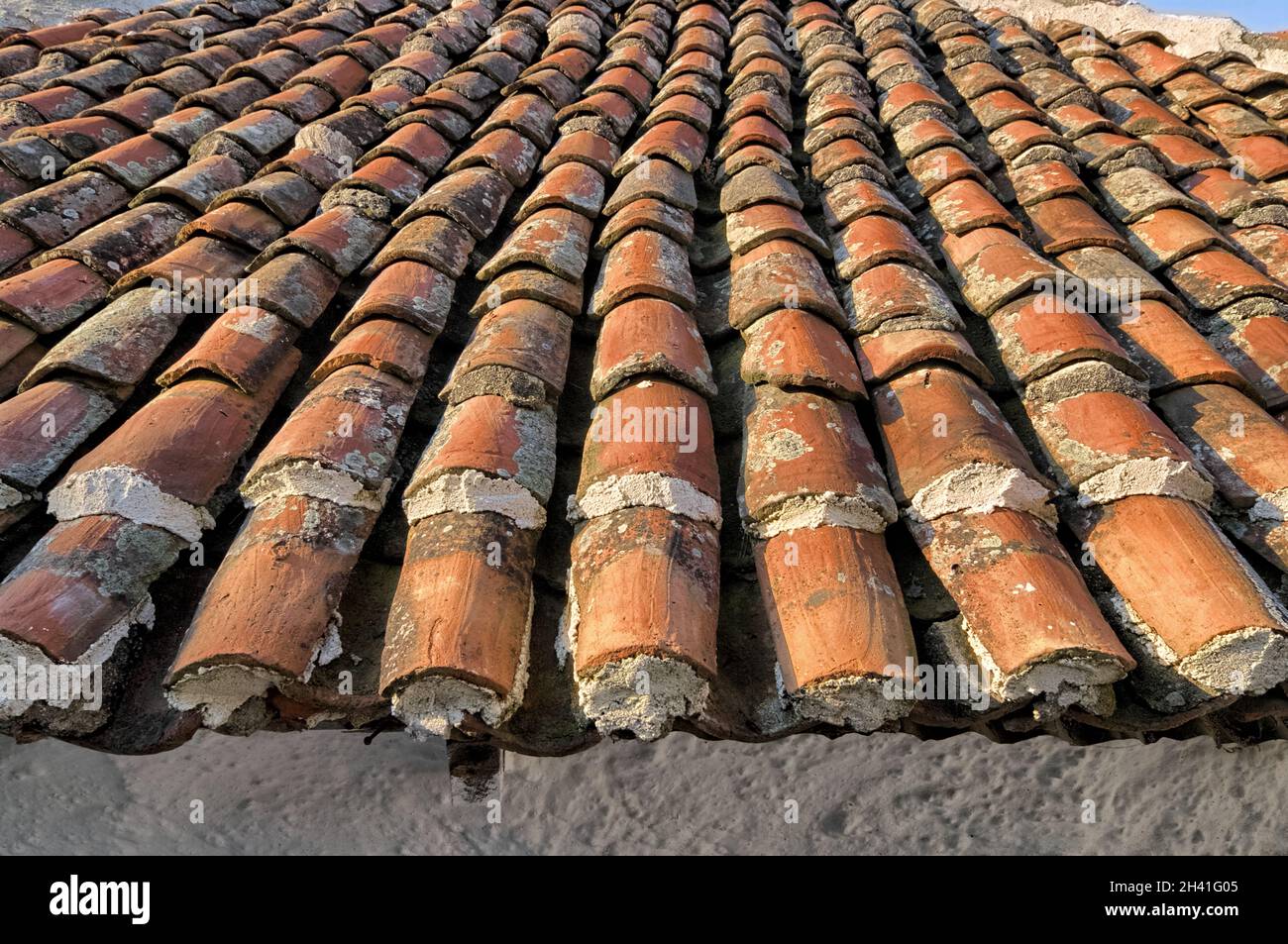 old pantile tiles handmade from clay on roof top of rural house in ...