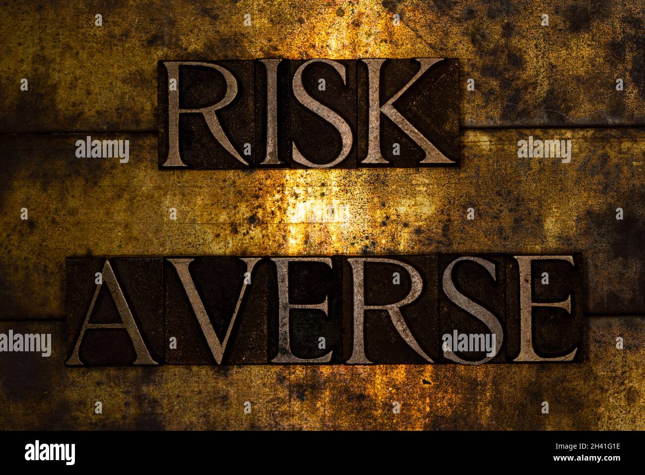 Risk Averse text message on textured grunge copper and vintage gold ...