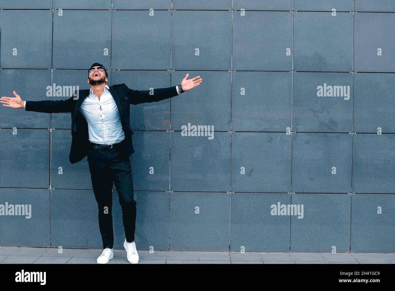 Arabic guy in business center stands smiling walking slow Stock Photo ...