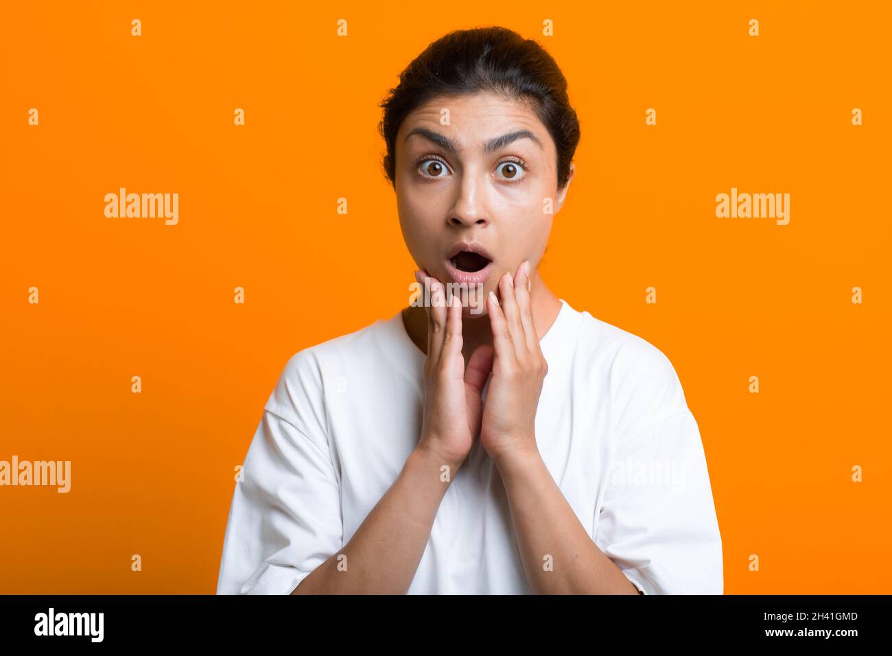 Portrait of young adult scared indian woman in T-shirt Stock Photo - Alamy