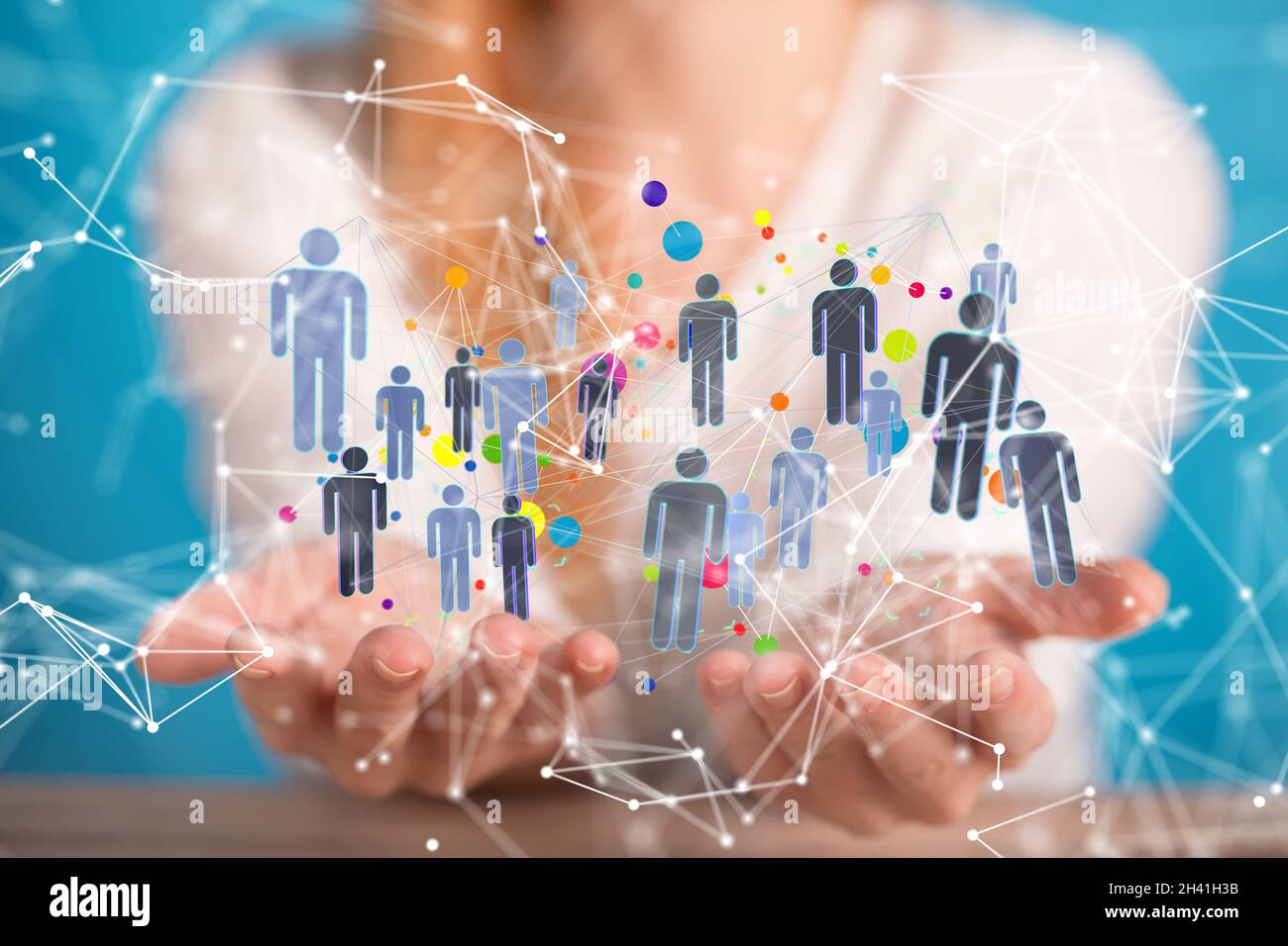 A 3D rendering of a group of floating people icons on a businesswoman's ...