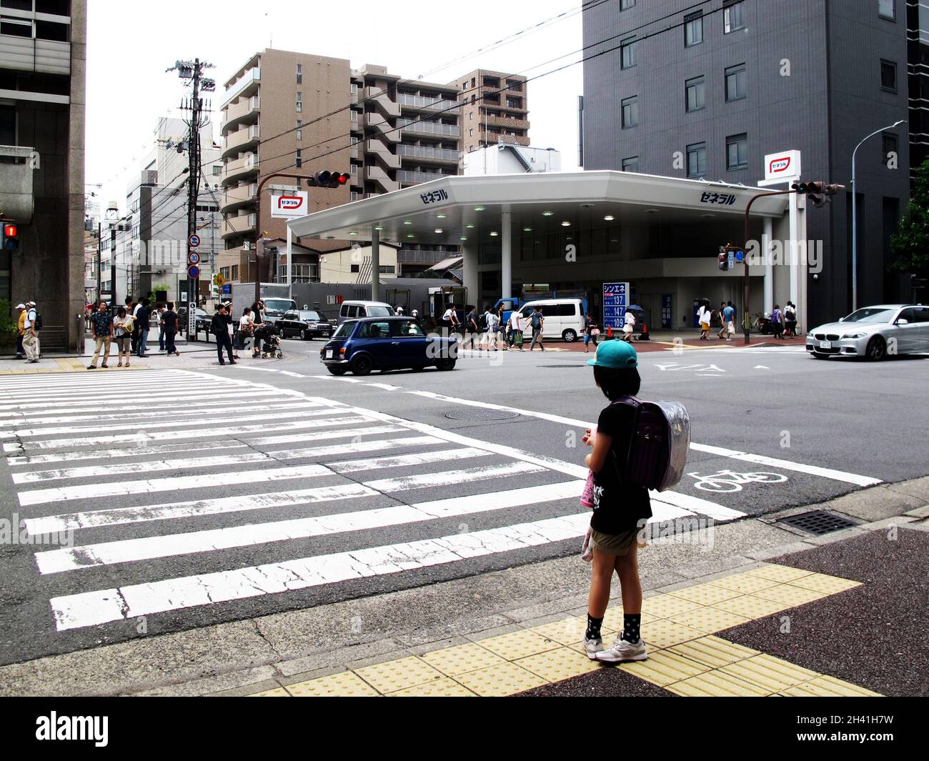 Children japanese girl waiting cross over road at crosswalk traffic ...
