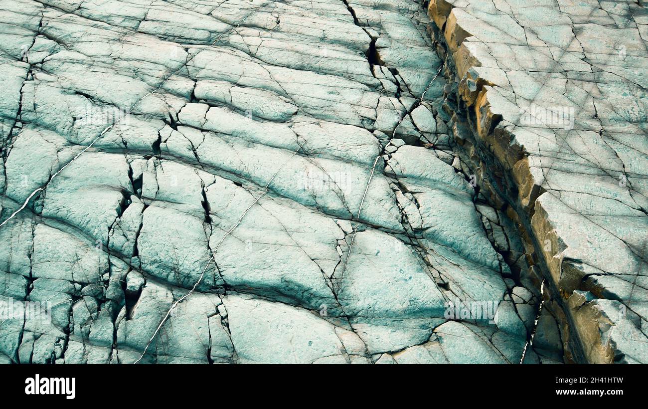 Cracked rock face along the Cornish coast, displaying striking patterns ...