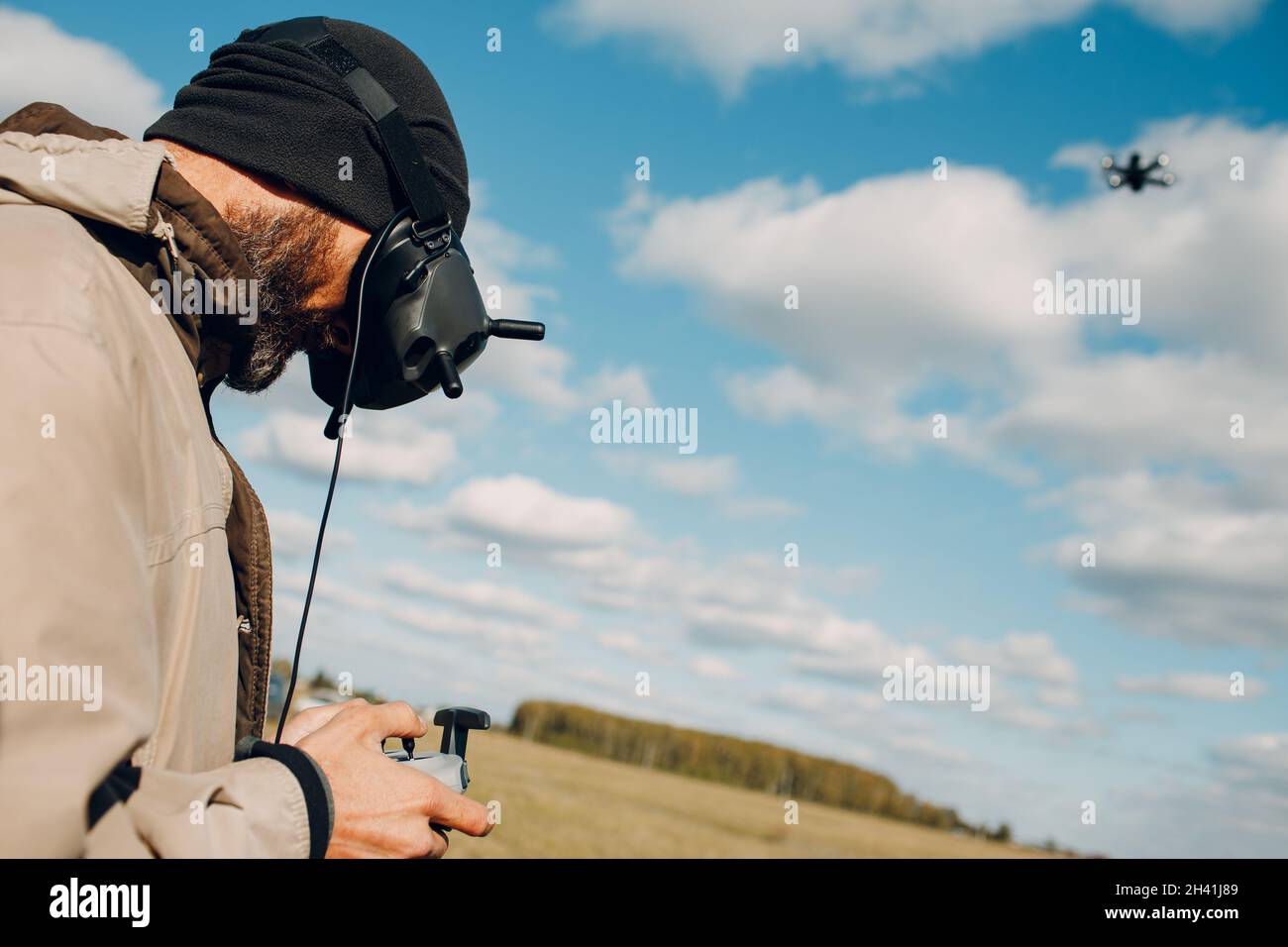 Man controlling fpv quadcopter drone with goggles antenna remote ...