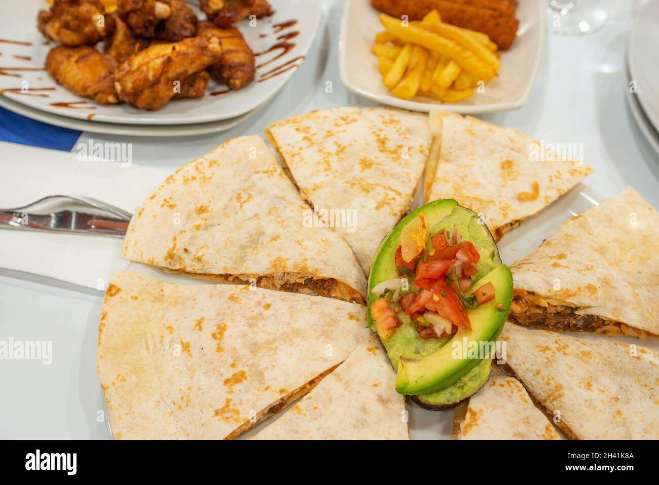 Mexican quesadillas stuffed with chicken tinga stew with ripe avocado ...