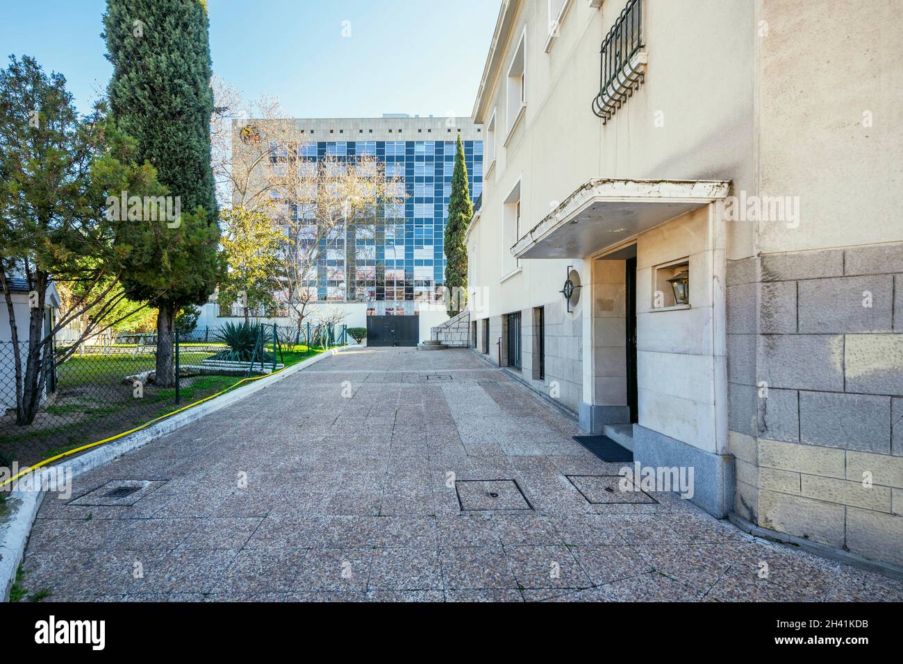 River stone conglomerate tile pavement with office building facade in ...