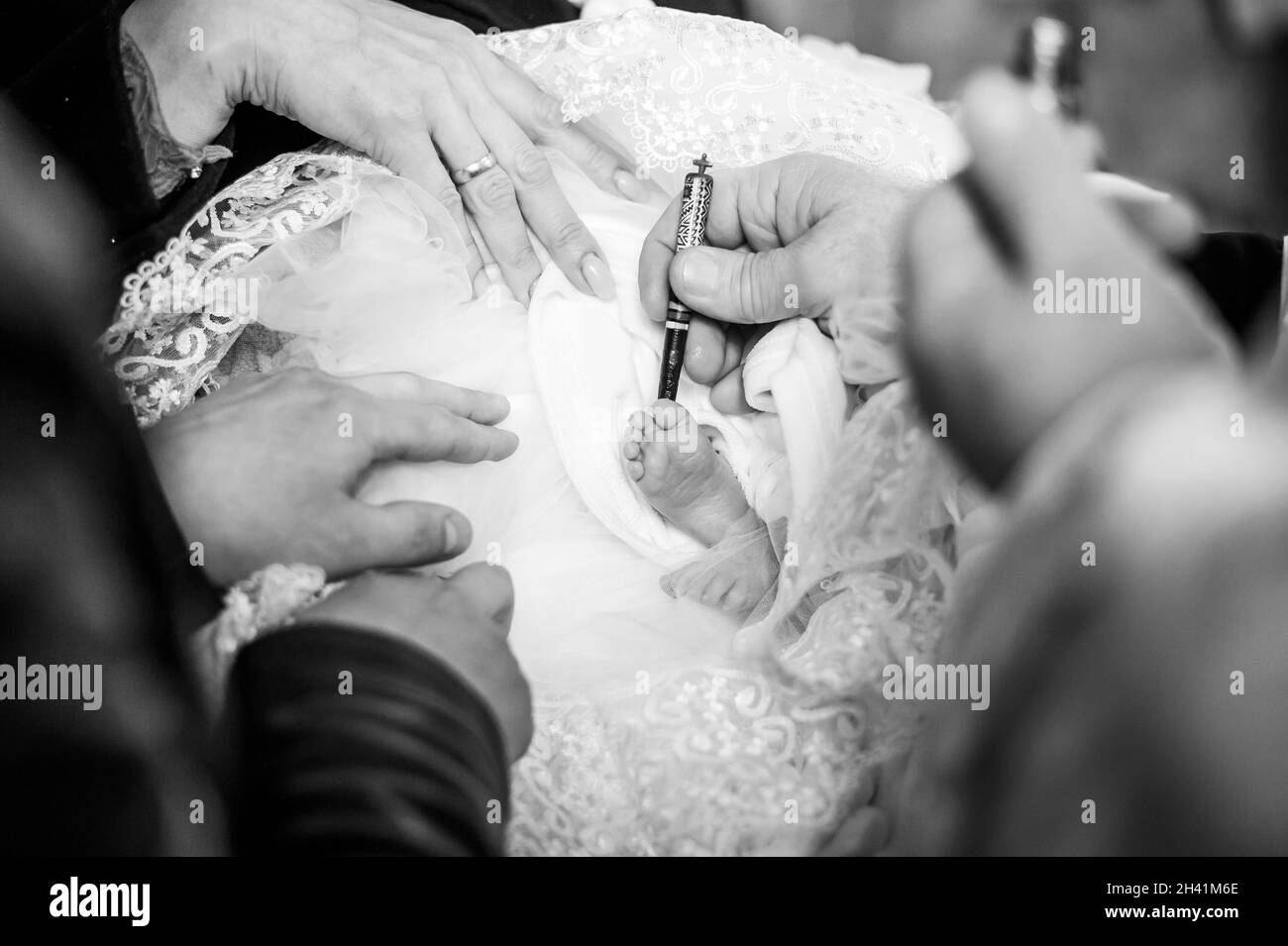 sacrament of baptism the priest baptizes the child with anointing Stock ...