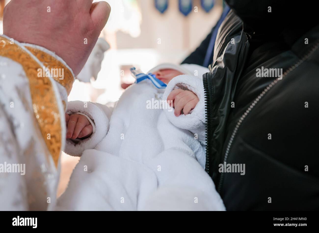 sacrament of baptism the priest baptizes the child with anointing Stock ...
