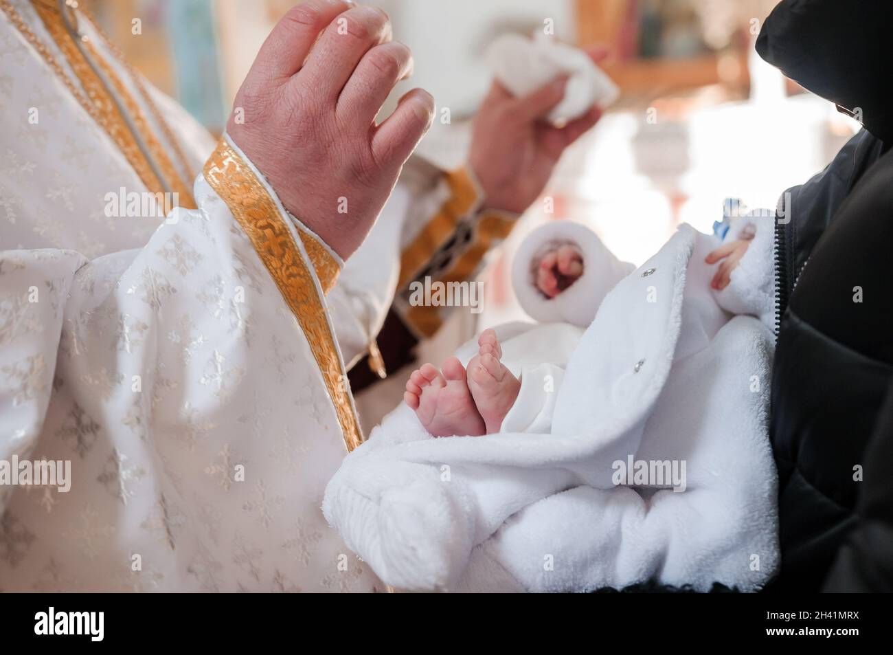 Priest anointing child hi-res stock photography and images - Alamy