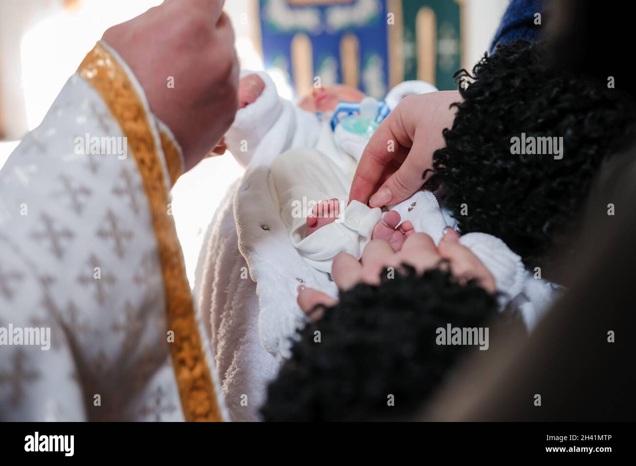 sacrament of baptism the priest baptizes the child with anointing Stock ...