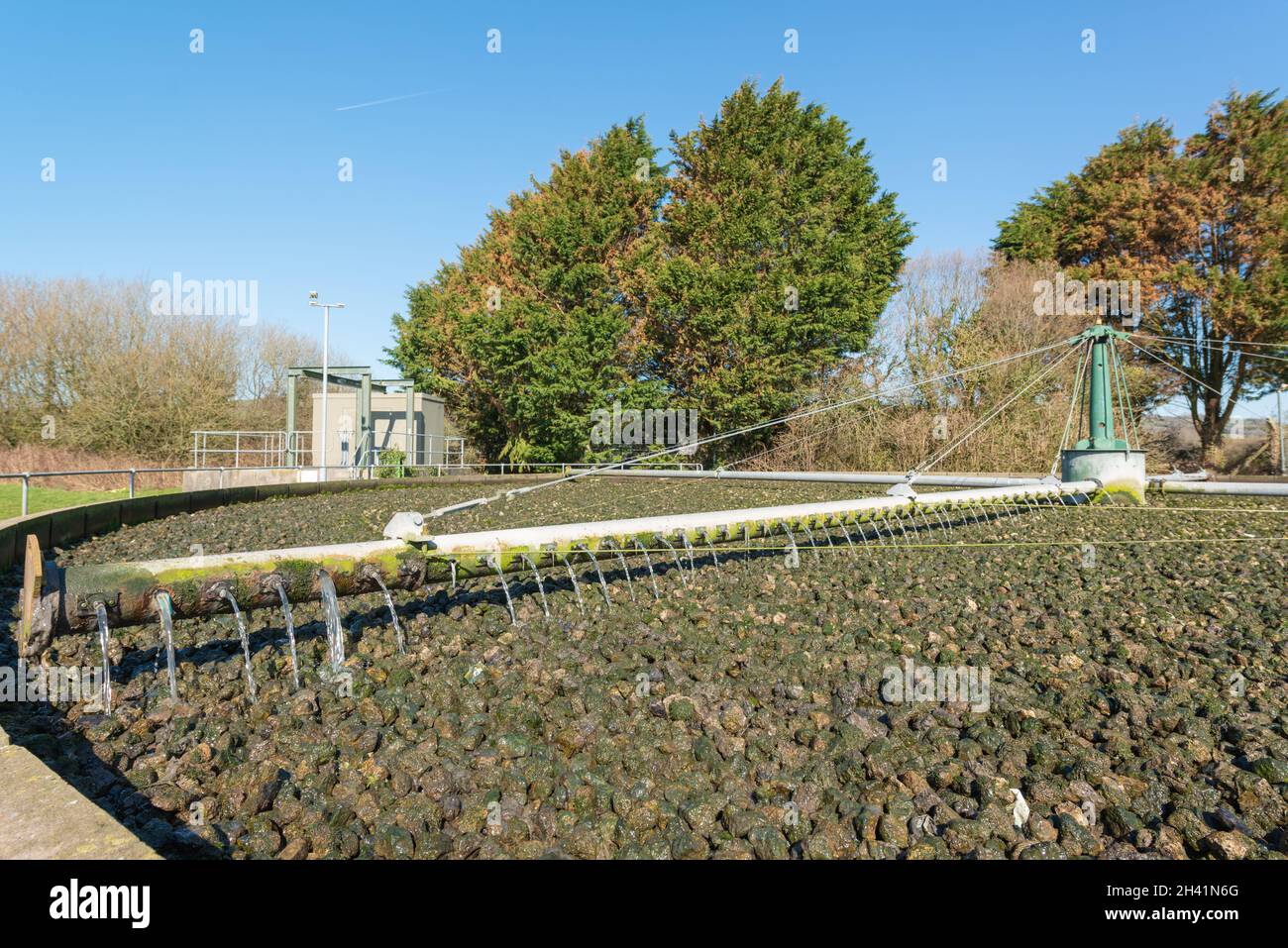 Rotary arm discharging waste water on filter bed, sewage treatment ...