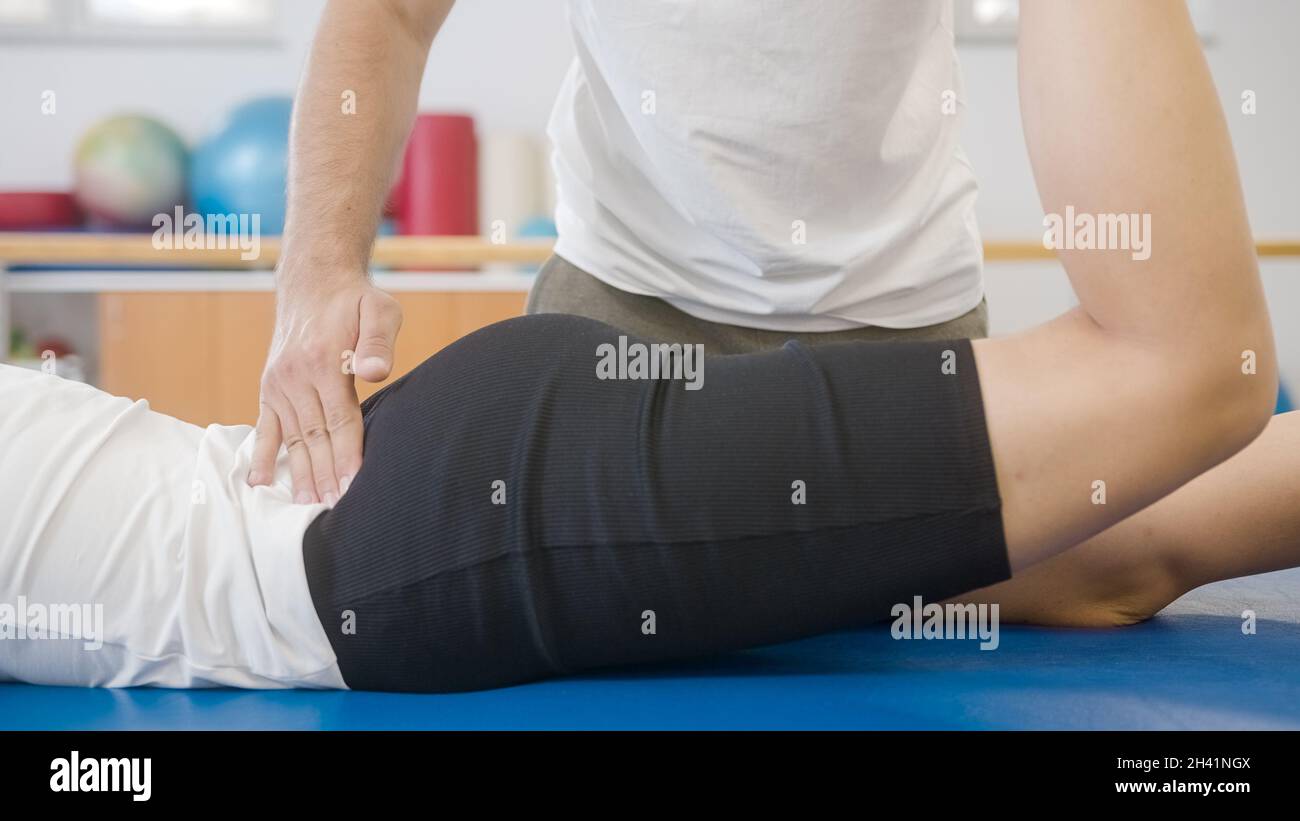 Physiotherapist giving an exercises treatment, to the female patient ...