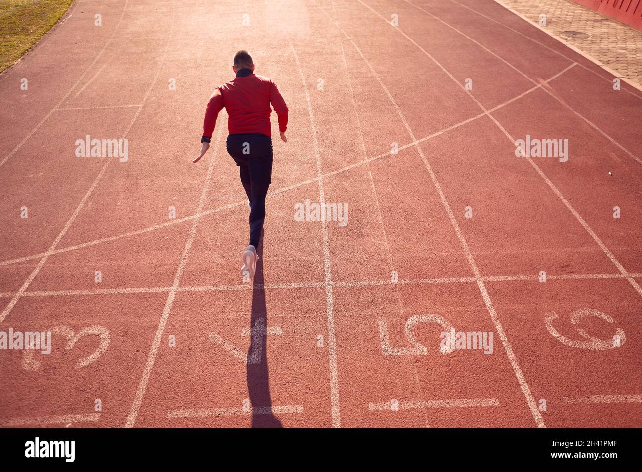 image of young adult male athlete from behind started run from the ...