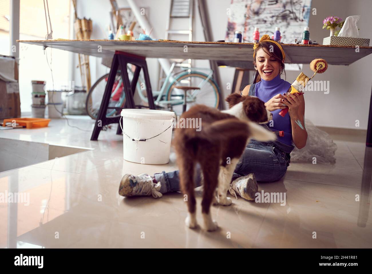young woman artist and her dog at the workshop .Creative inspired mood ...