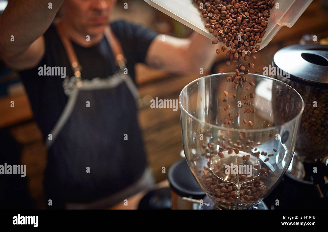 Worker pouring roasted coffee hi-res stock photography and images - Alamy