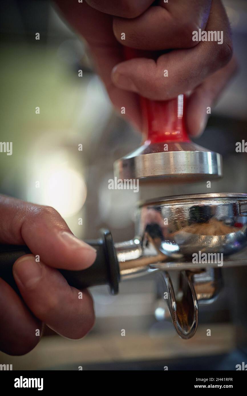 Close-up view of barman's hands who is pressing fragrant and aromatic ...