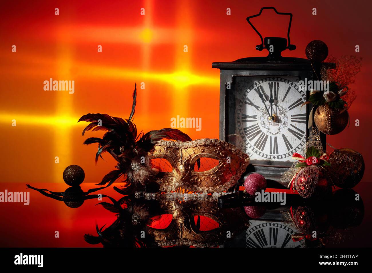 Vintage clock with Christmas decorations and carnival mask. Copy space ...
