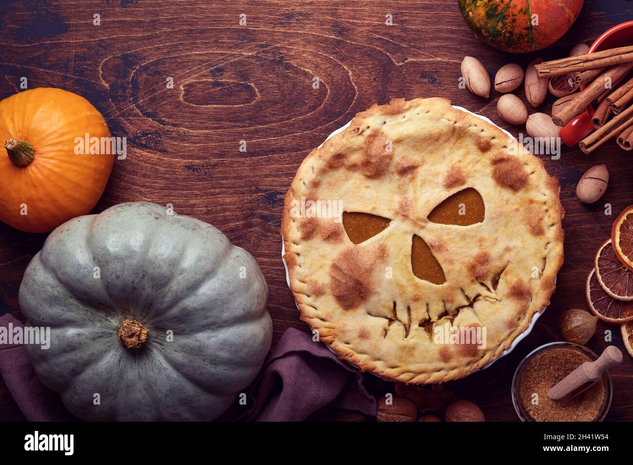 Halloween food. Homemade pumpkin pie or tart with a scary face for ...