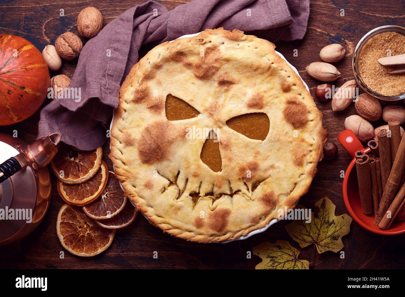 Halloween food. Homemade pumpkin pie or tart with a scary face for ...