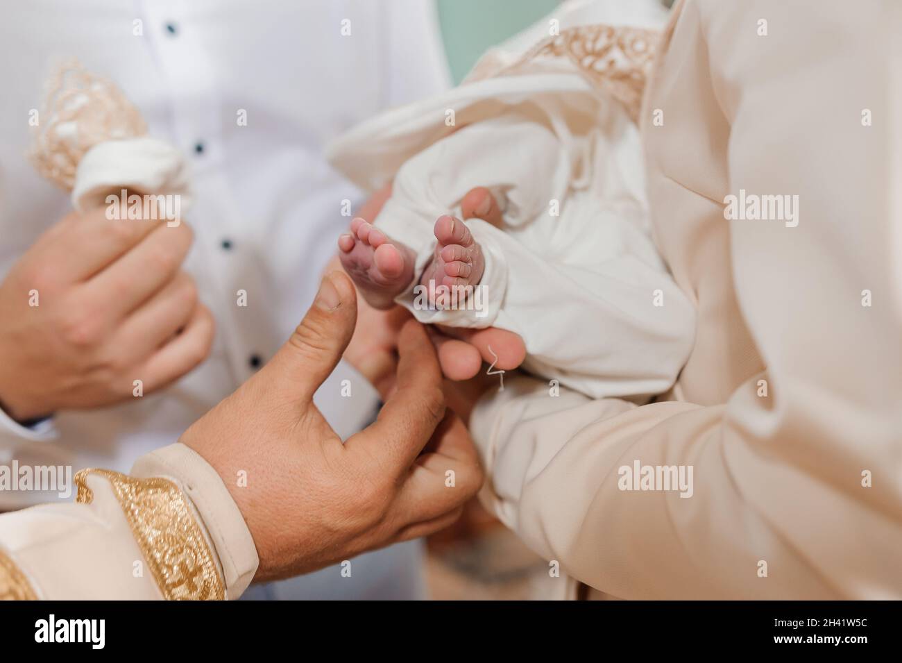 sacrament of baptism the priest baptizes the child with anointing Stock ...