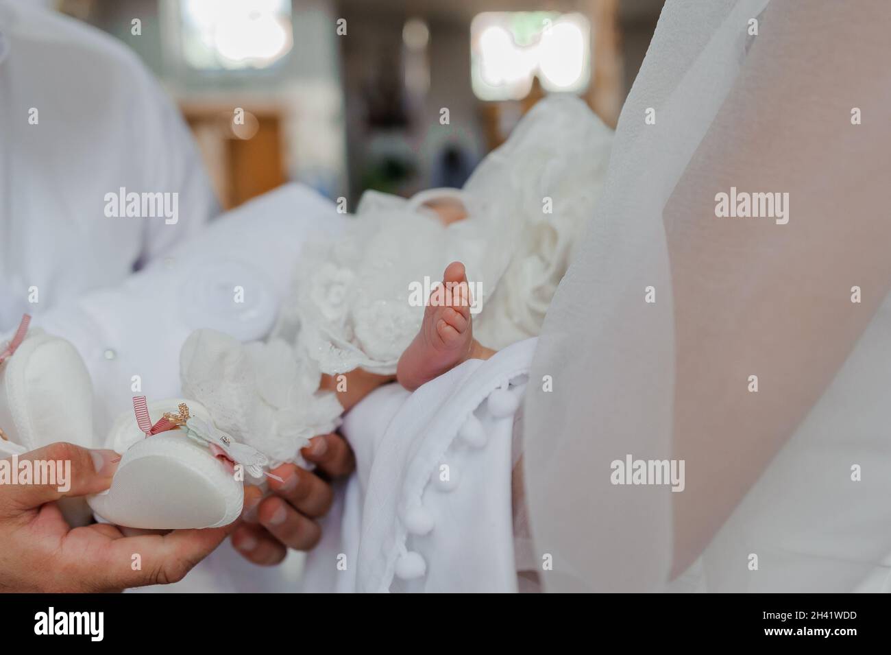 sacrament of baptism the priest baptizes the child with anointing Stock ...