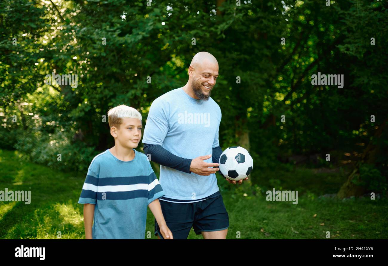 Father son play football hi-res stock photography and images - Alamy