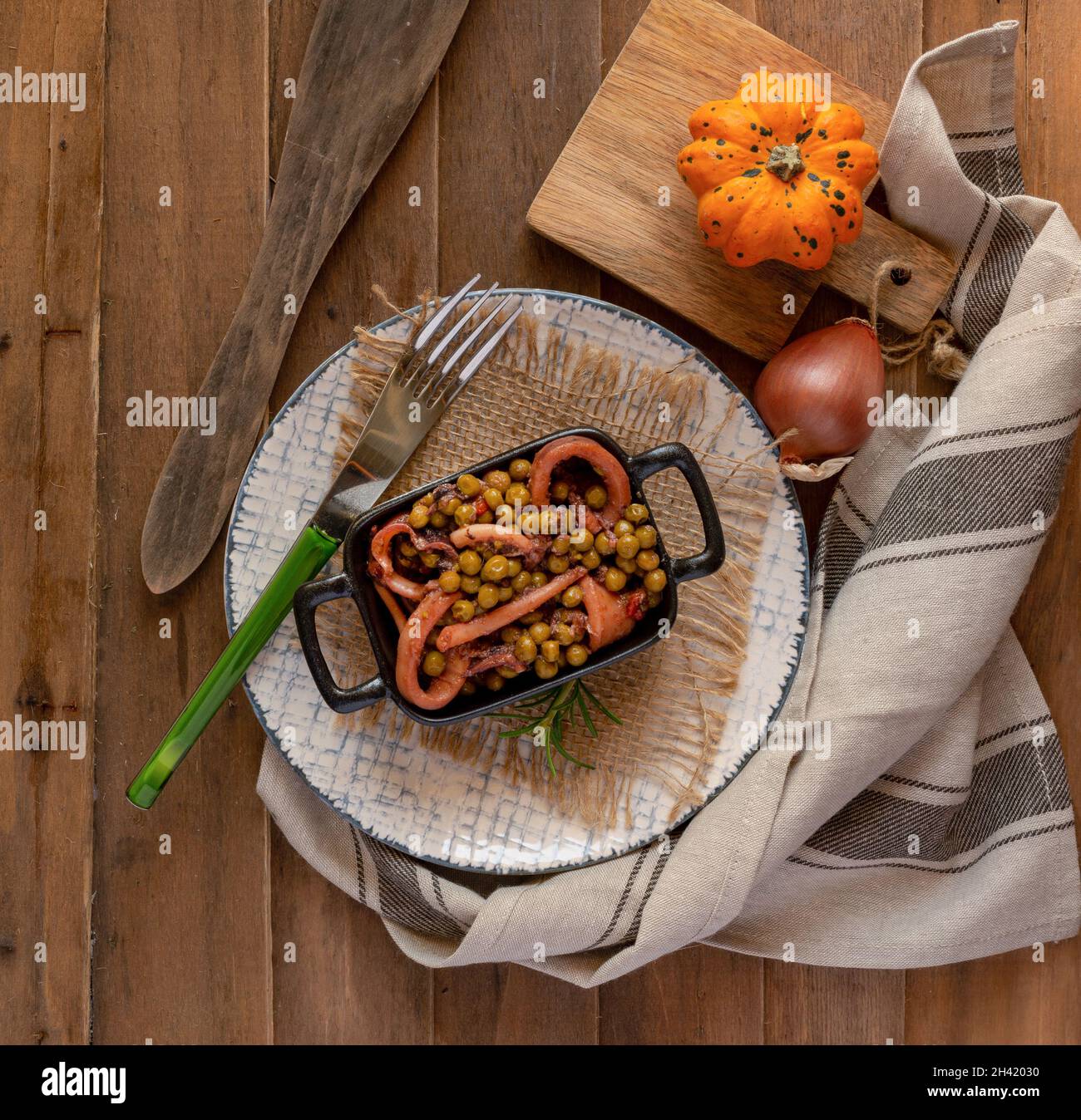 top view squid cut in a circle with peas and tomato Stock Photo - Alamy