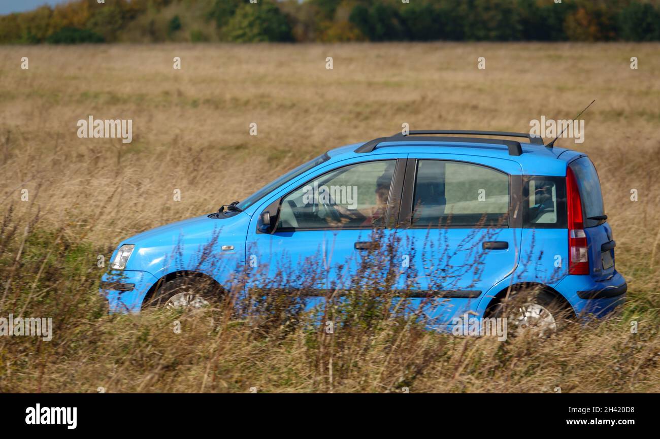 light blue fiat panda dynamic motor car driving across Salisbury Plain ...