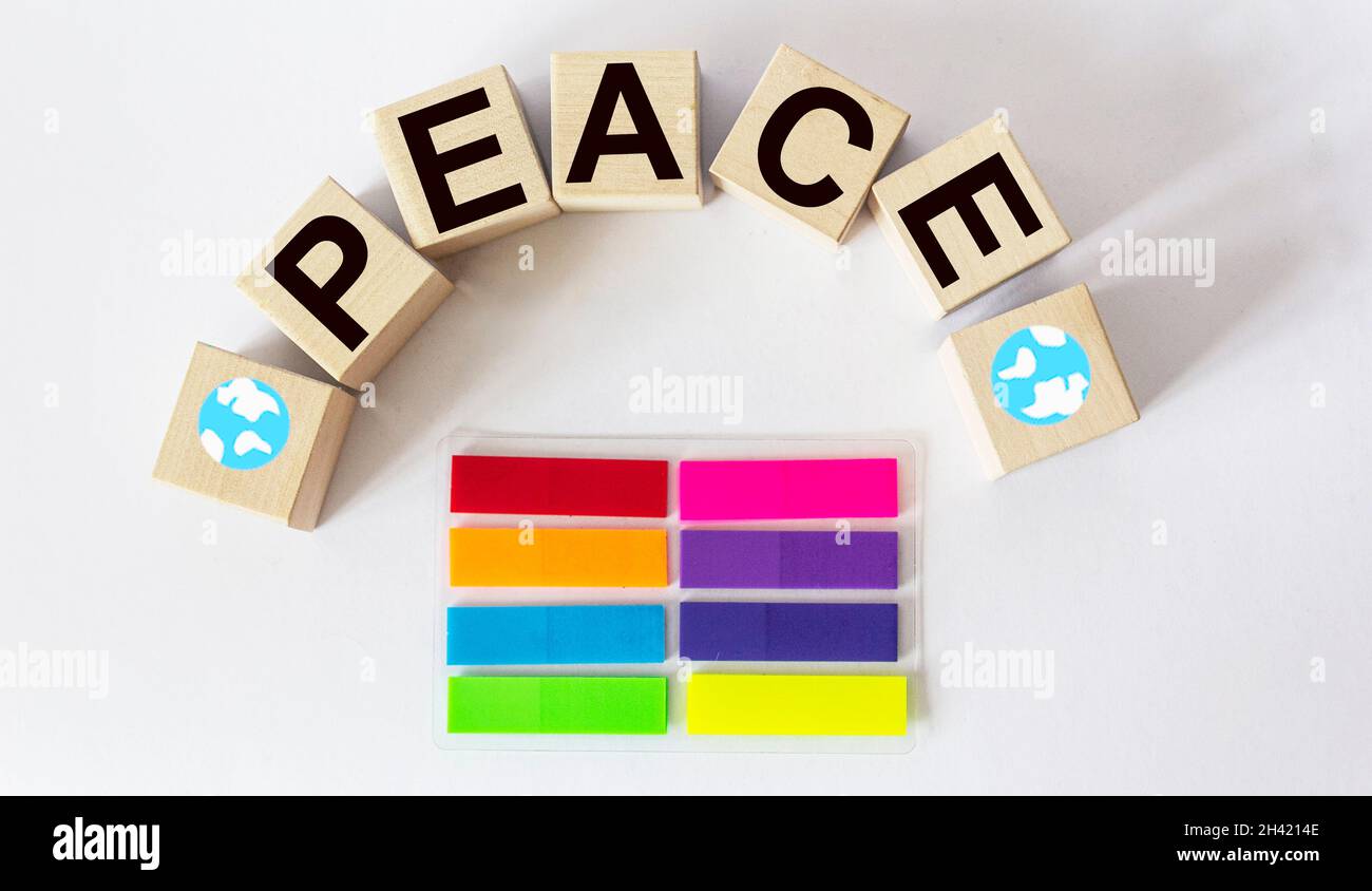 The text PEASE is written on wooden blocks, on a white background. The ...