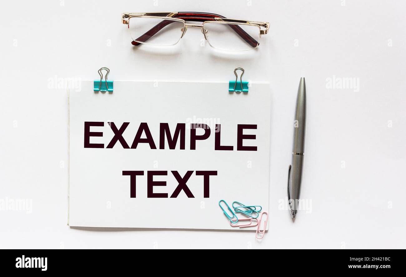 A sheet of paper with the text EXAMPLE TEXT on a white background Stock ...