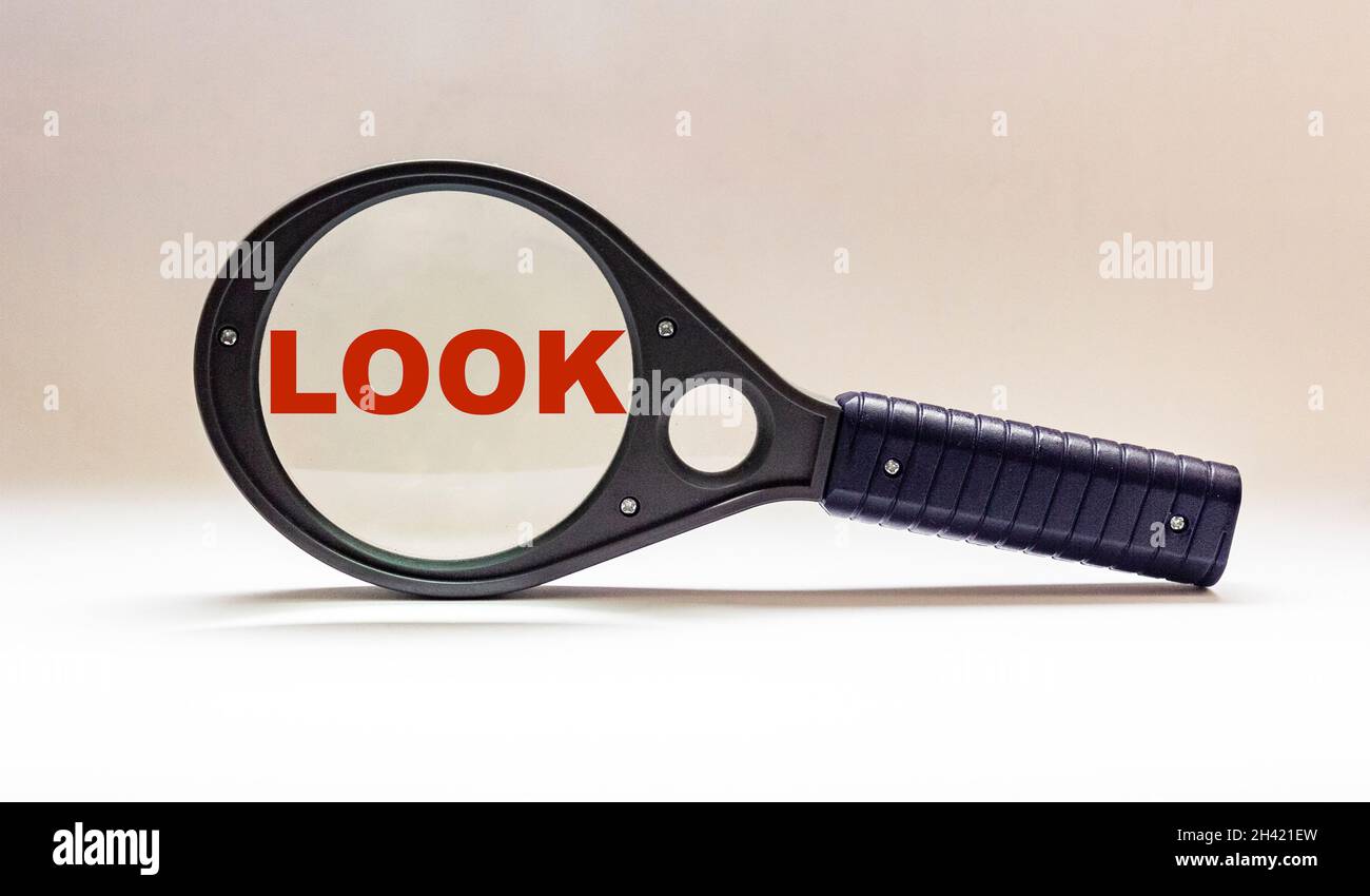 Magnifying glass, on a white background with the word LOOK Stock Photo ...