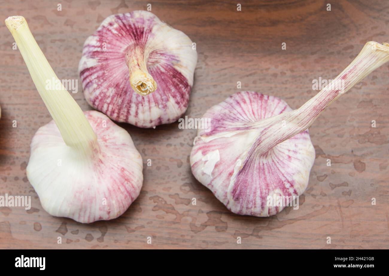 Three heads of garlic on a wooden table, kid from above, close-up Stock ...